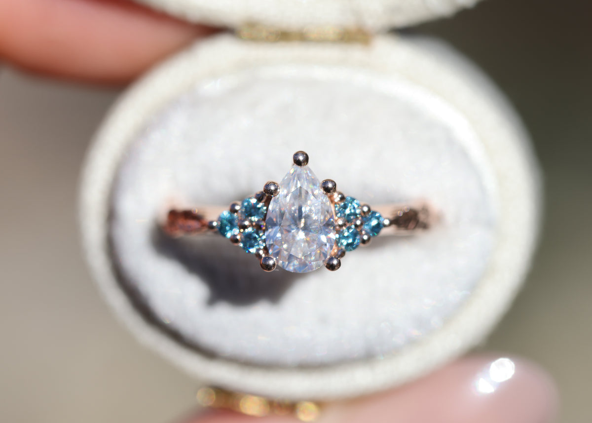 Seraphina with pear moissanite center and aqua irradiated diamonds ...